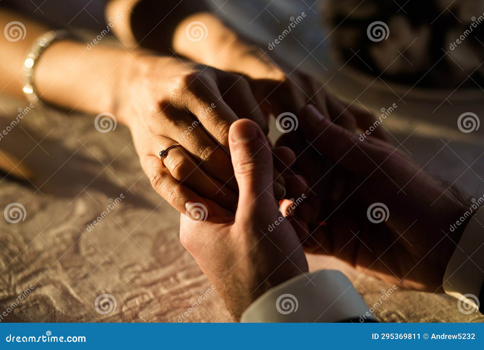 Intimate Moment of Couple Holding Hands with Engagement Ring in Warm ...