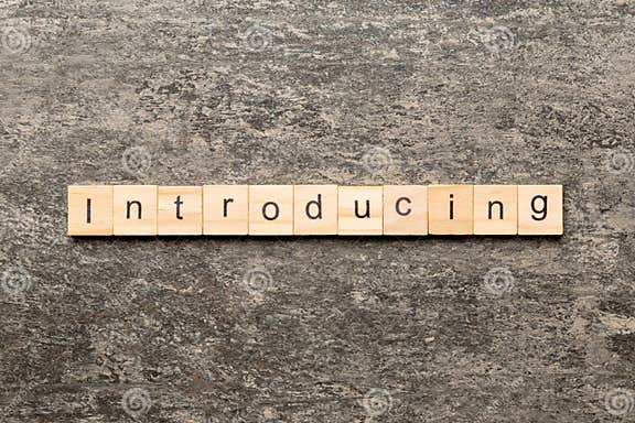 Introducing Word Written on Wood Block. Introducing Text on Table ...