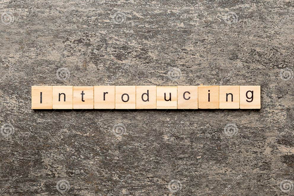 Introducing Word Written on Wood Block. Introducing Text on Table ...