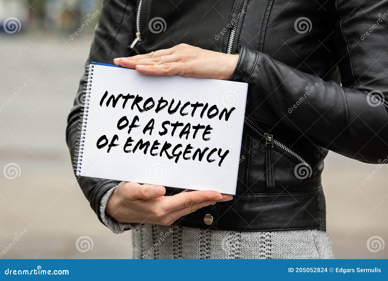 Introduction of a State of Emergency. Notebook in a Woman`s Hand Stock ...