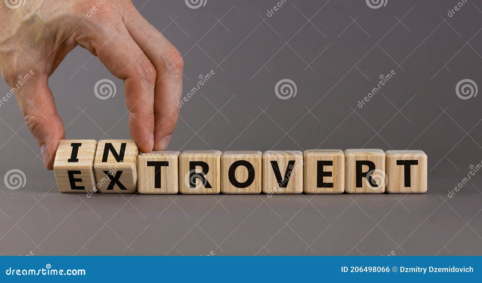 Introvert Or Extrovert Symbol. Hand Turns Cubes And Changes The Word ... Introvert Or Extrovert Symbol. Hand Turns Cubes And Changes The Word ...