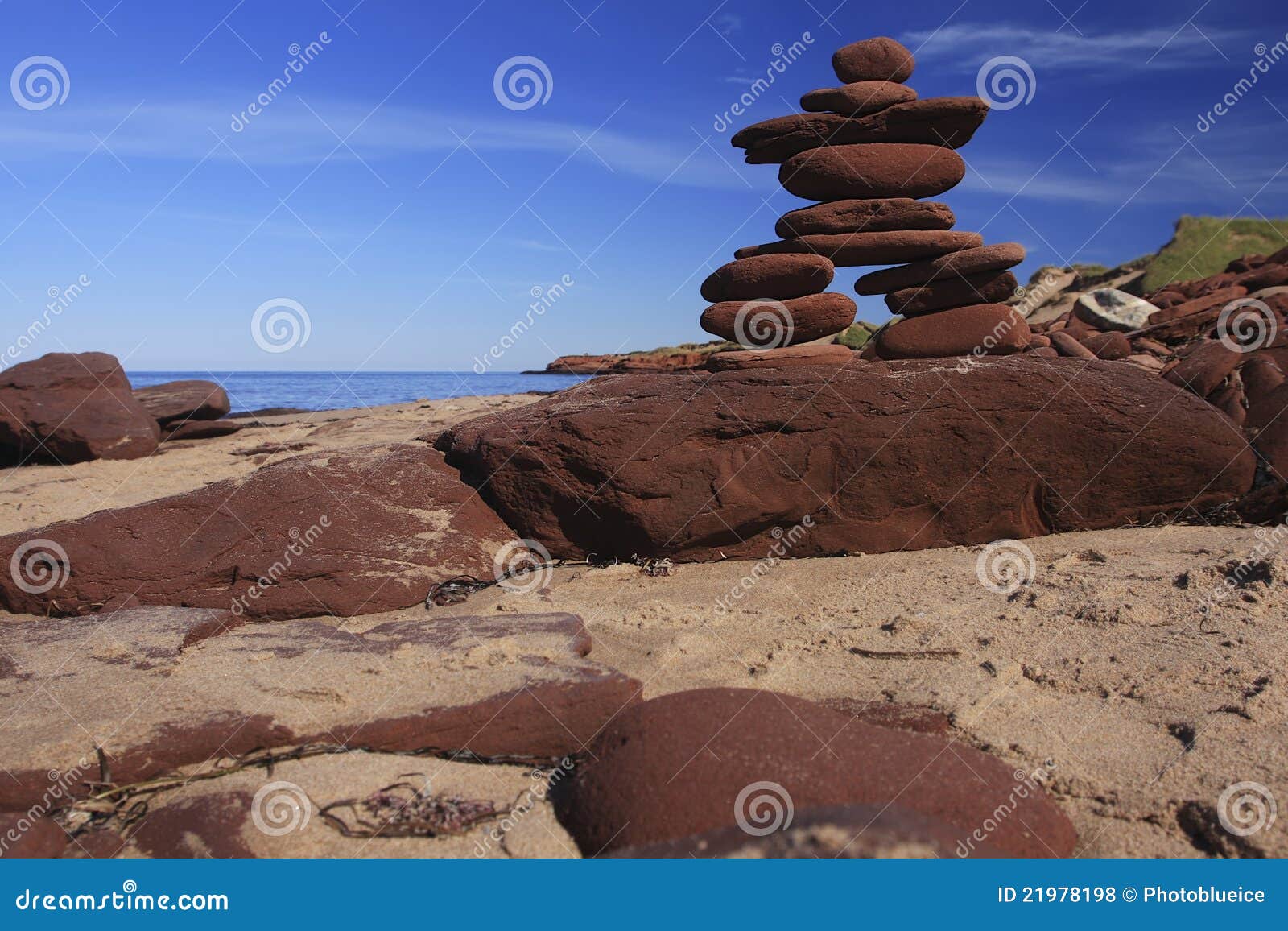 Inukshuk made of Red rocks stock photo. Image of culture - 21978198