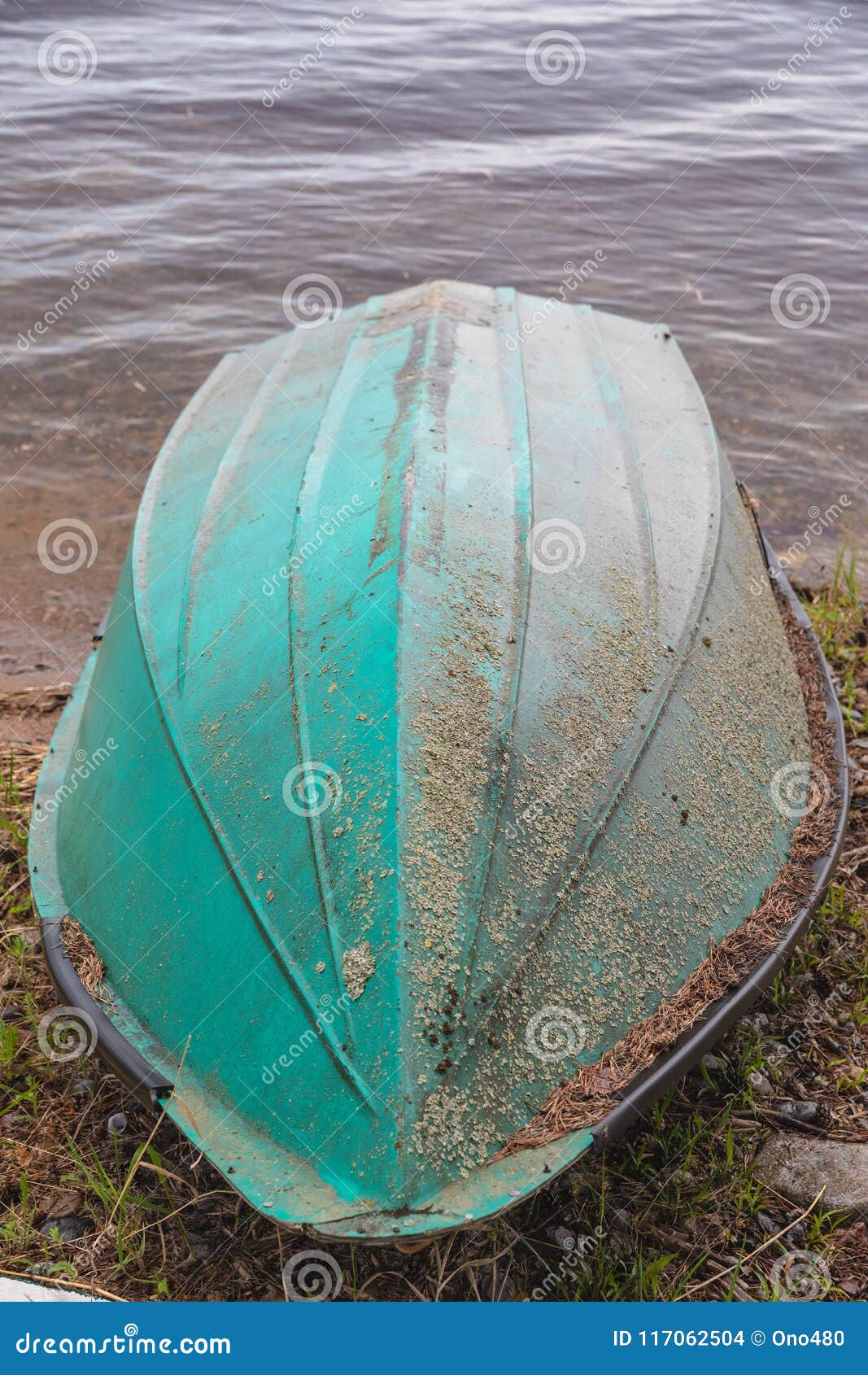 The Old Inverted Green Color Boat Lies On The Sea Shore In Cloudy Day ...