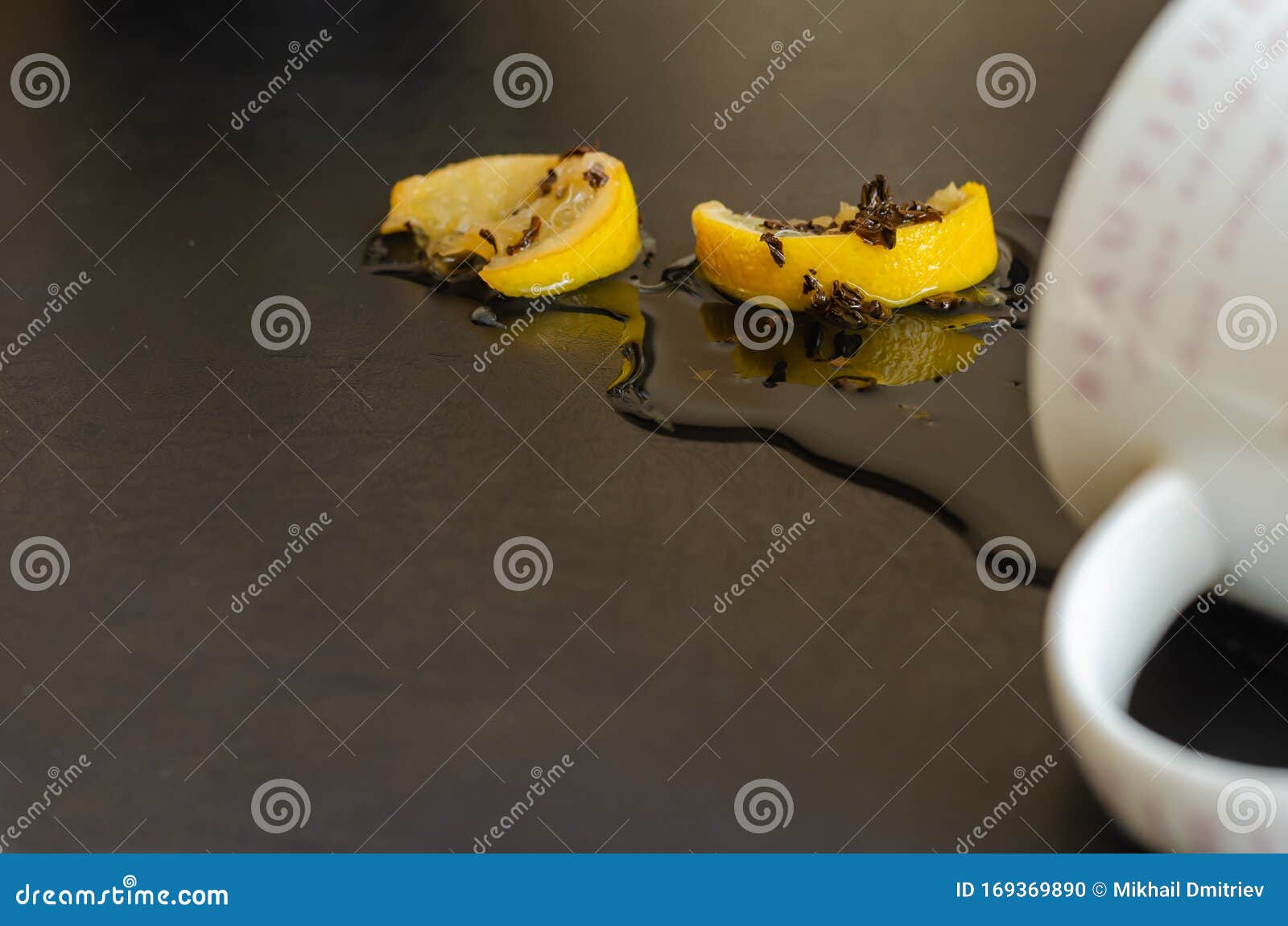 Inverted Cup and the Rest of Spilled Tea on a Dark Table Stock Photo ...