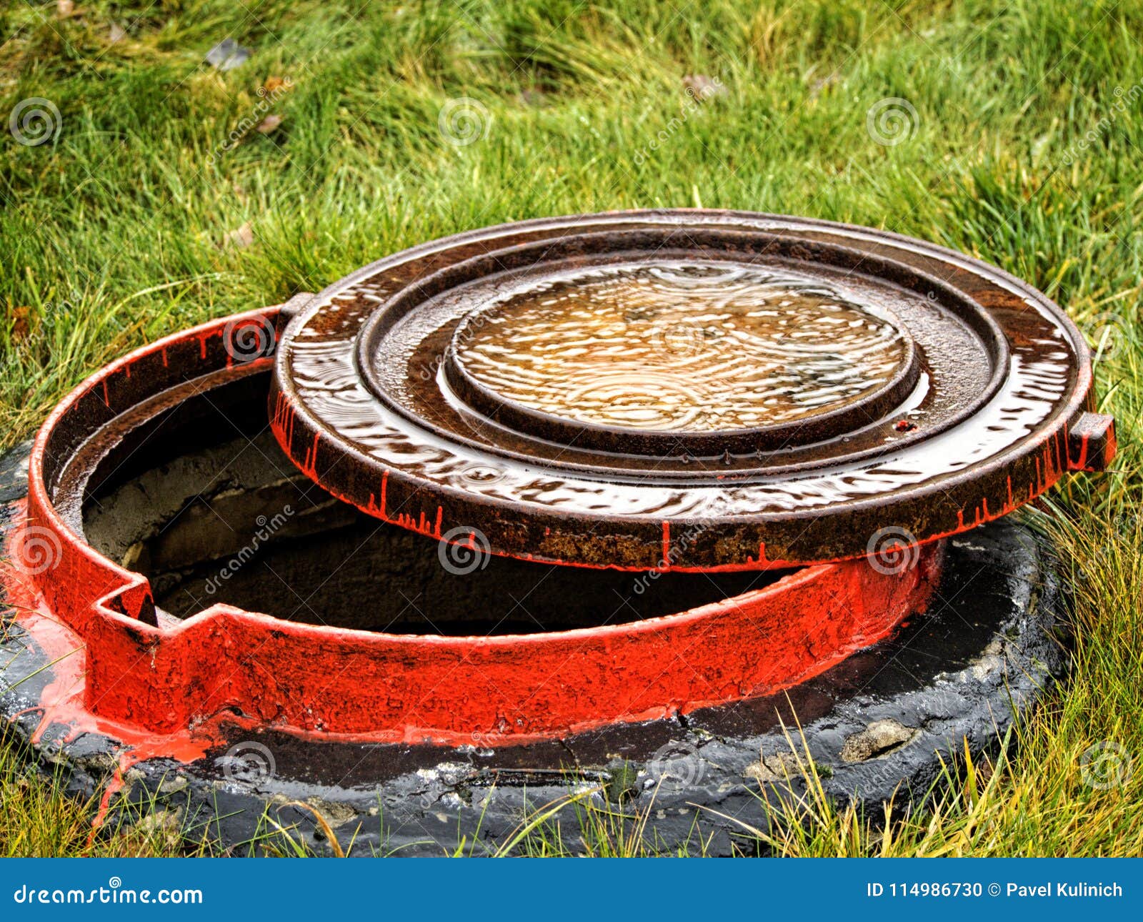 Inverted Manhole Cover in the Rain Stock Photo - Image of invert, open ...