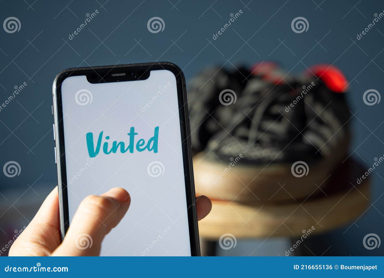 Iphone with Vinted Logo on Screen with Hand in Front of Style Shoes ...