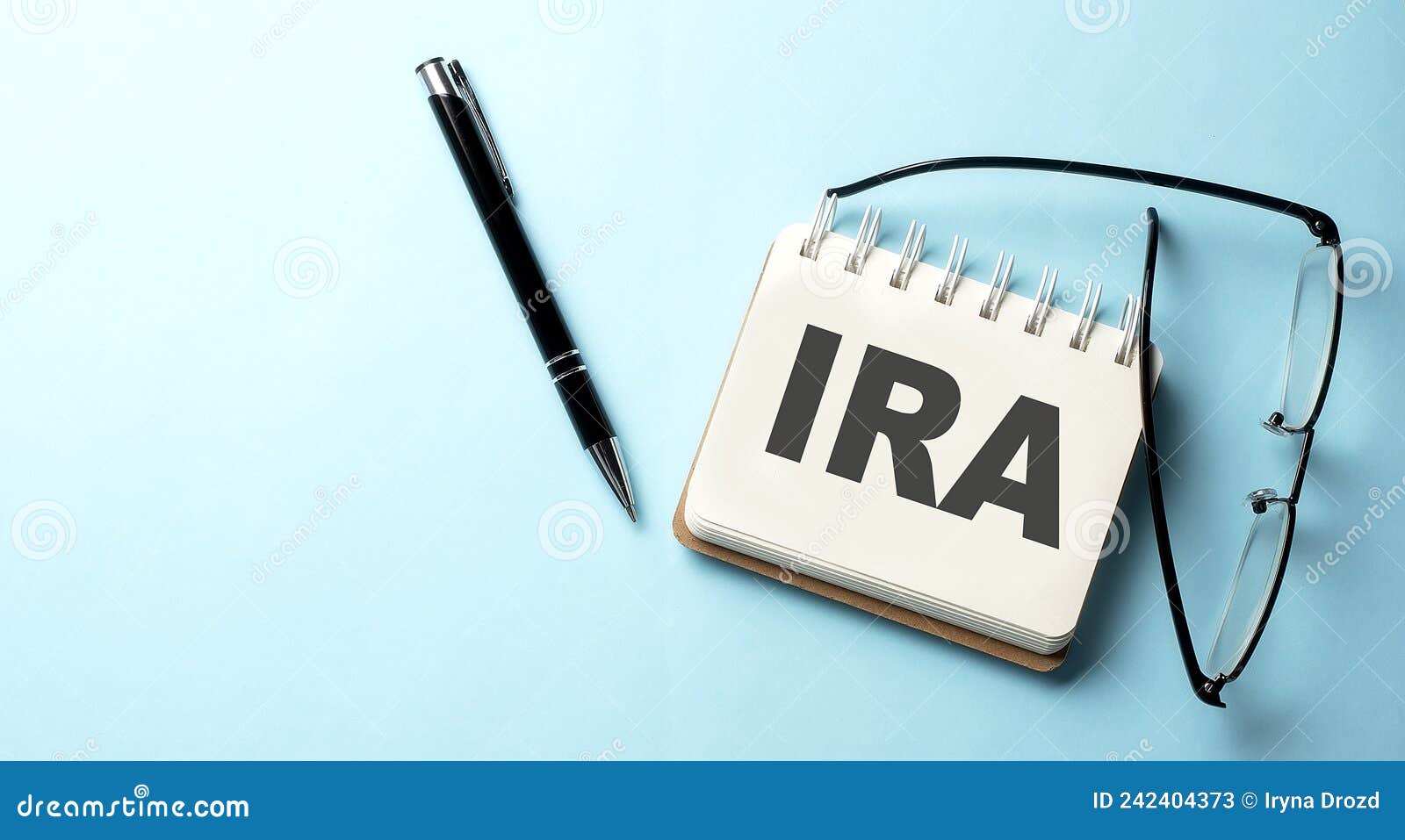 IRA Text Written on a Notepad on the Blue Background Stock Image ...