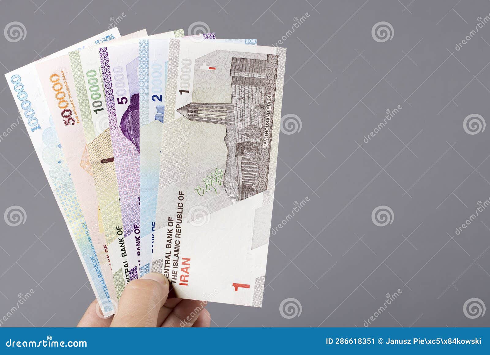 Iranian Money in the Hand on a Gray Background Stock Image - Image of ...