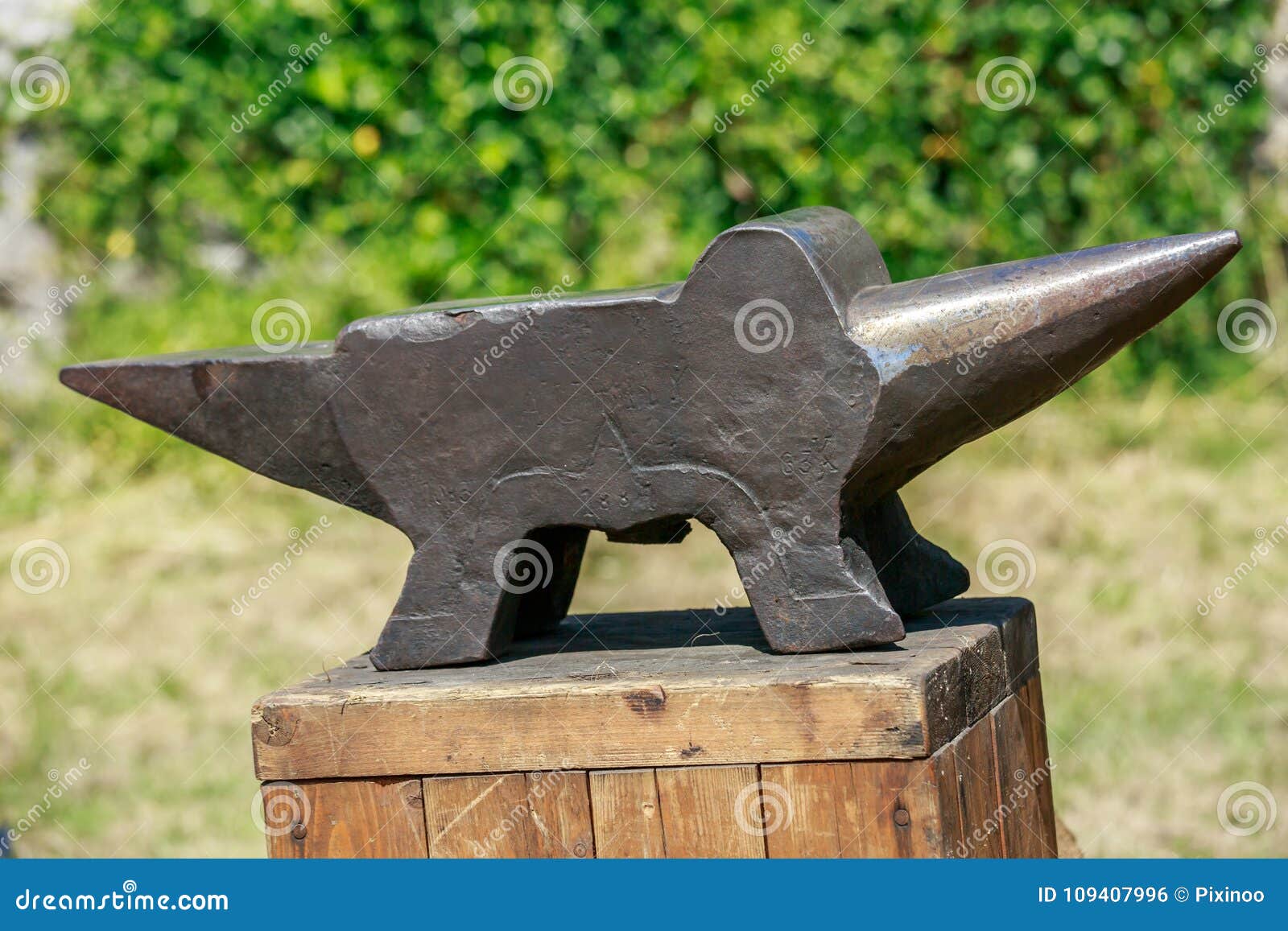 Iron anvil on wooden table stock photo. Image of medieval - 109407996