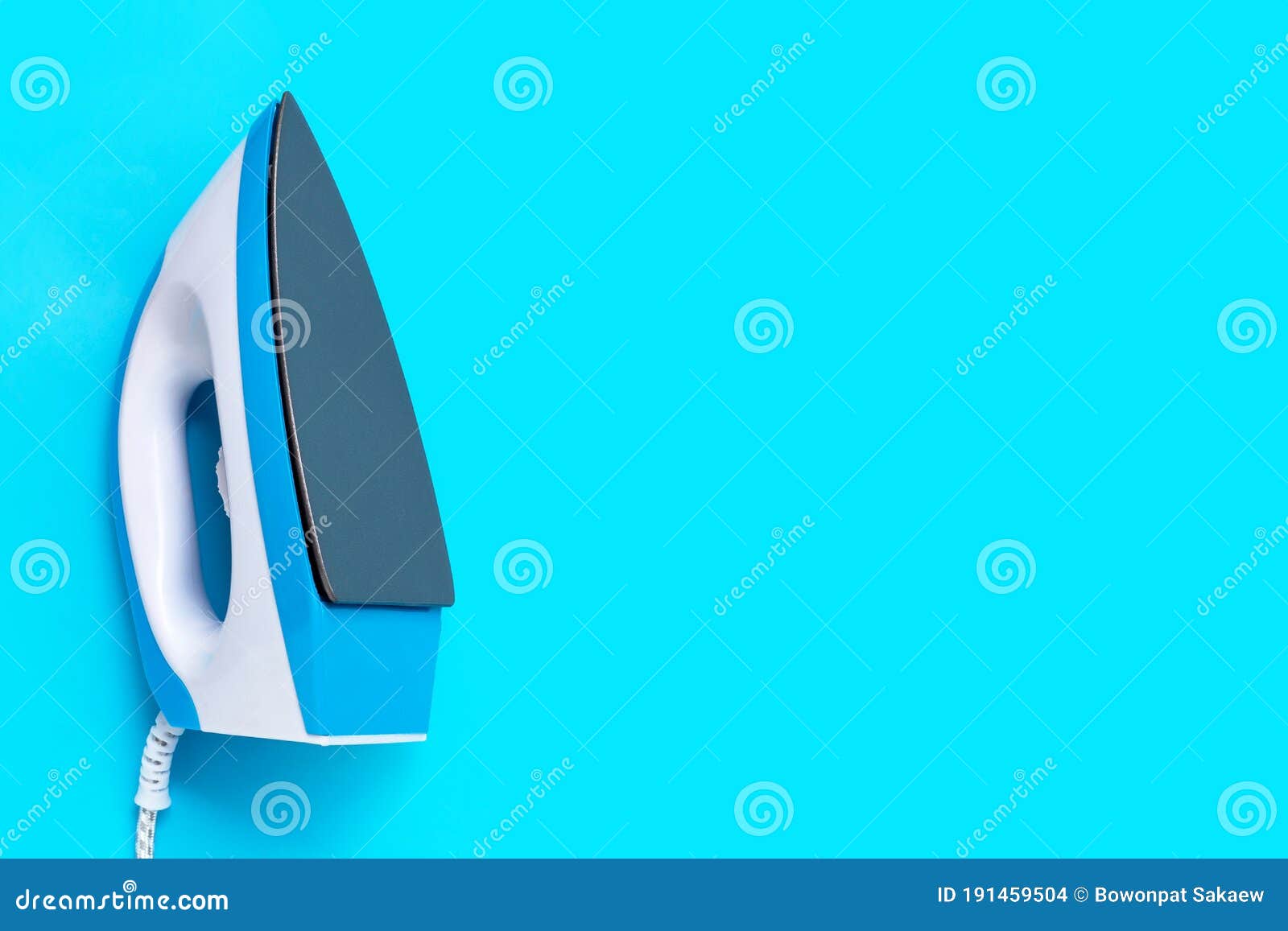 Iron on Blue Background. Top View Stock Photo - Image of folded ...