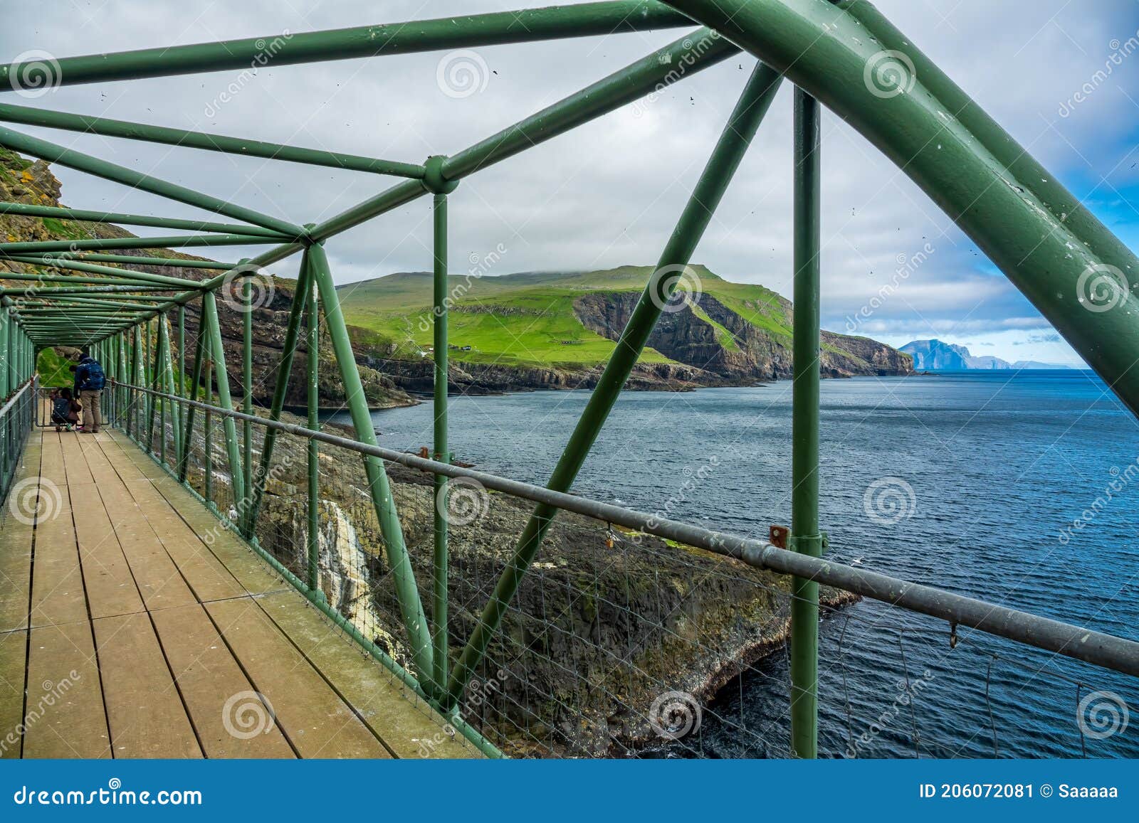 Iron Bridge in the Mykines Island with Unrecognizable Tourists Stock ...