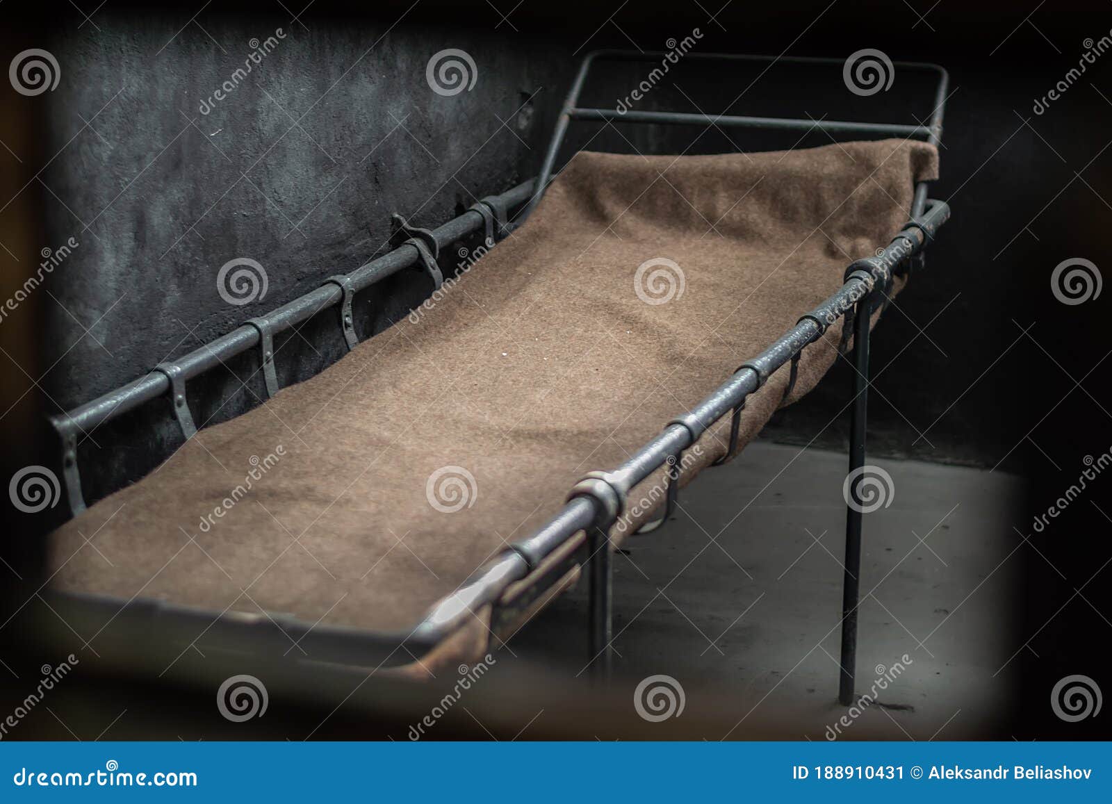 Iron cot in a jail cell stock image. Image of steel - 188910431