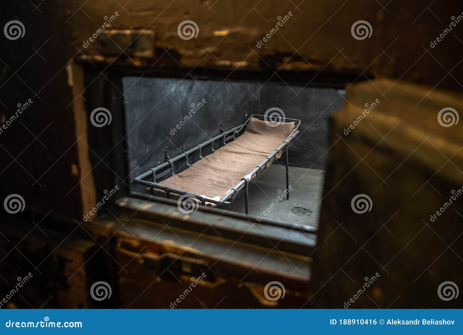 Iron cot in a jail cell stock photo. Image of window - 188910416