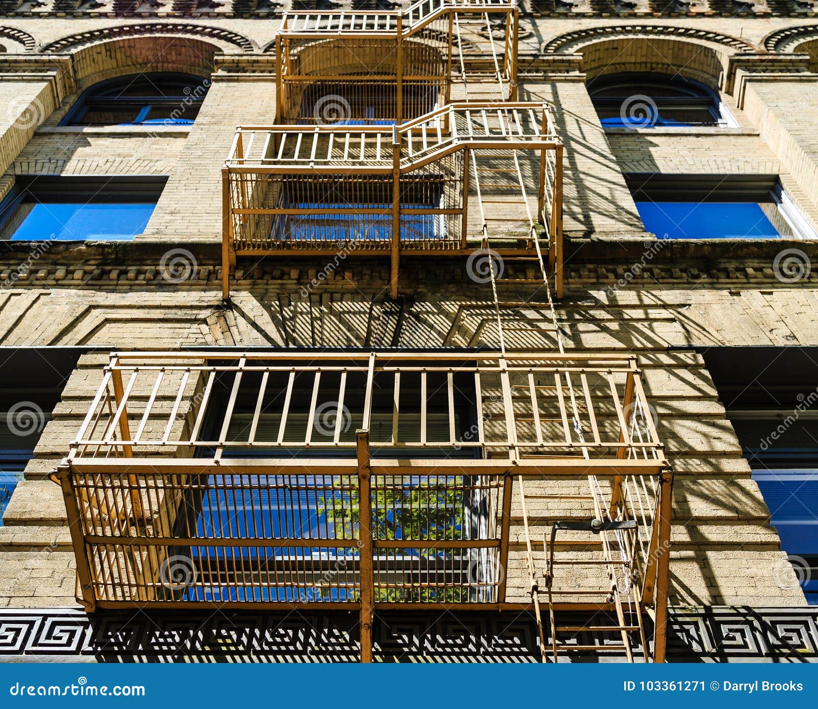 Iron Fire Escape on Blue Windows Stock Image - Image of steps, iron ...