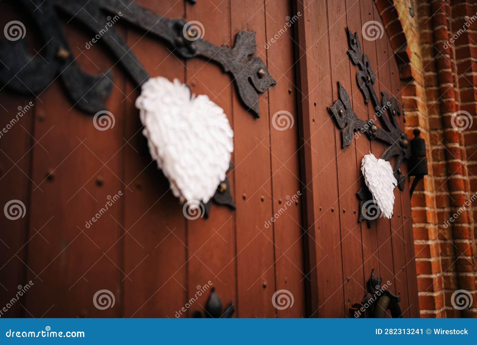 Iron Gate Adorned with Several White Hanging Hearts, Symbolizing Love ...