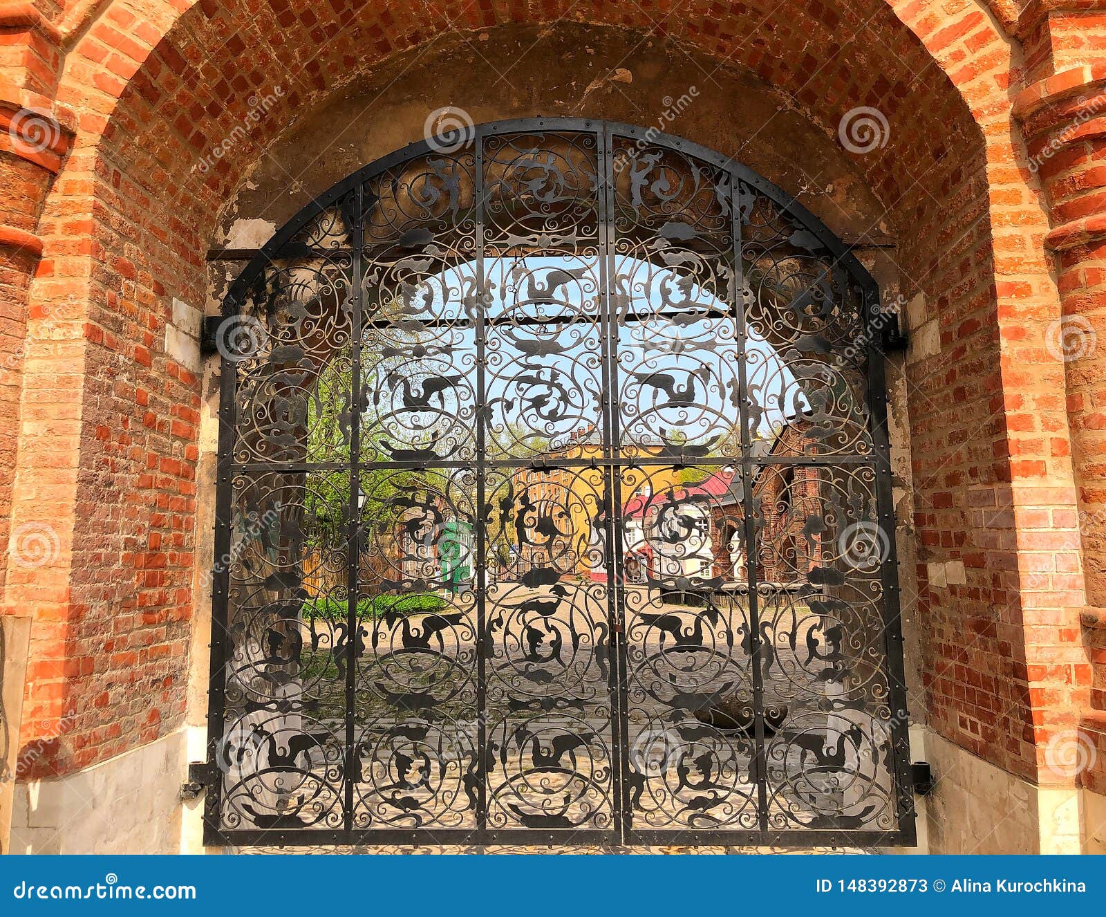 Iron Gate with a Pattern on the Background of a Stone Wall Stock Image ...