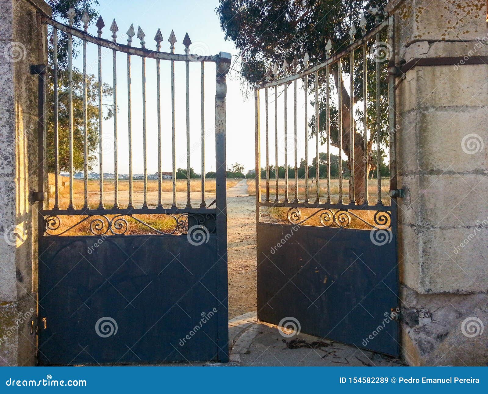 Iron Gate with a Small Opening To Let a Person with Visible Narrow Path ...