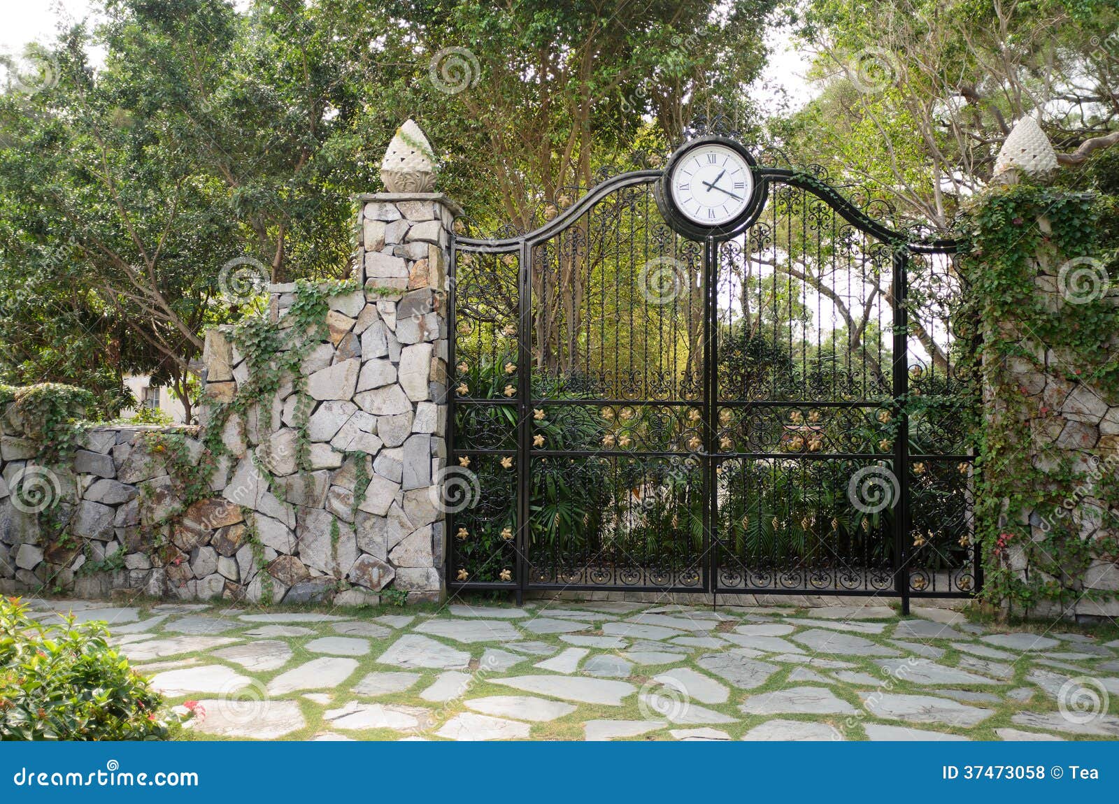 Iron gate in stone wall stock photo. Image of idyllic - 37473058