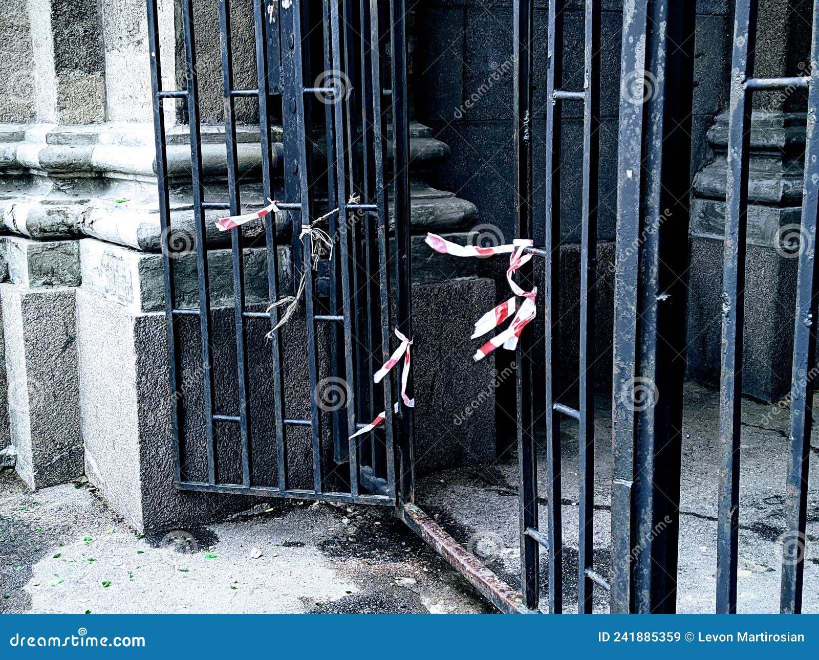 Iron Gate with Torn and Warning Red and White Tapes. Stock Image ...