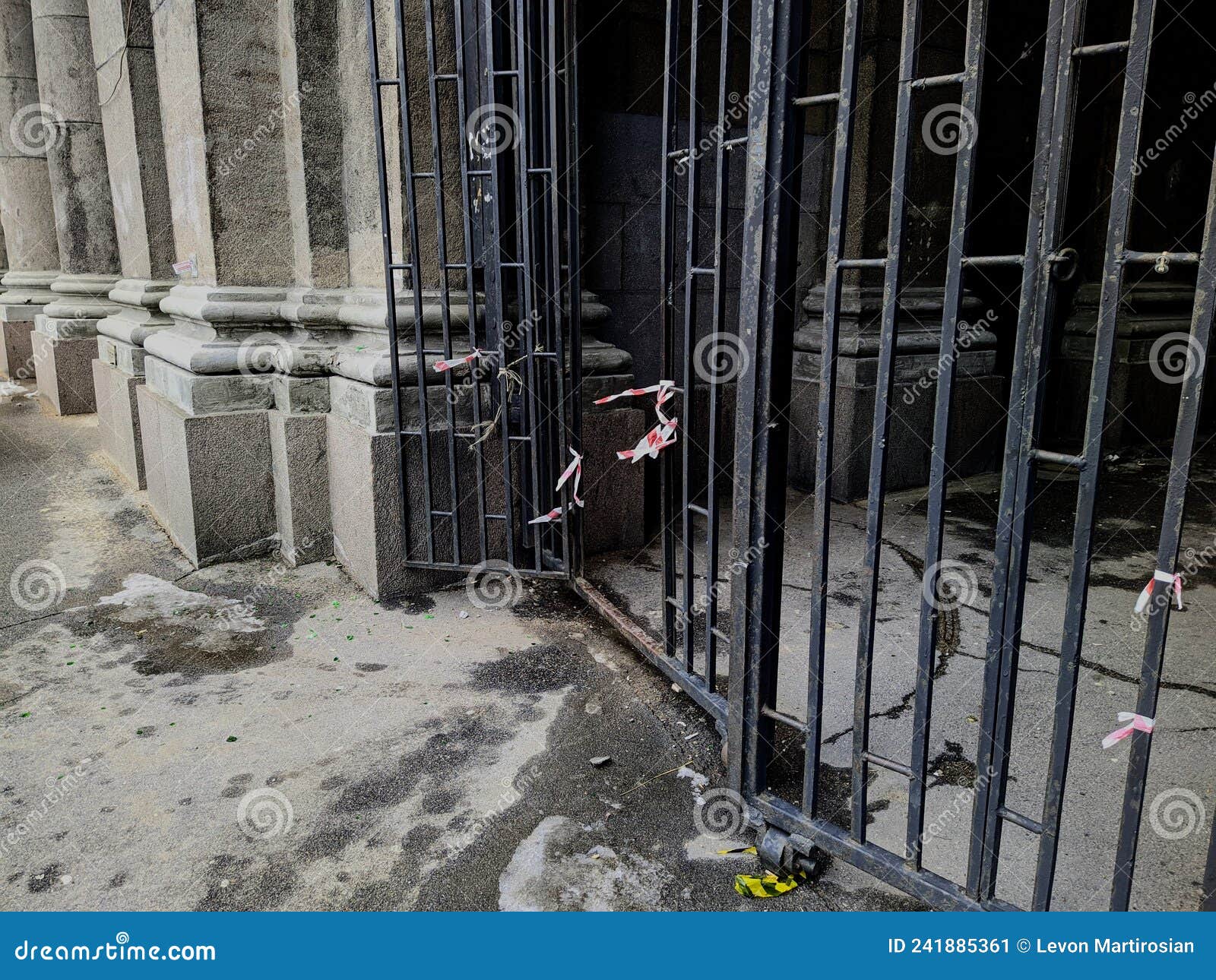 Iron Gate with Torn and Warning Red and White Tapes. Stock Image ...