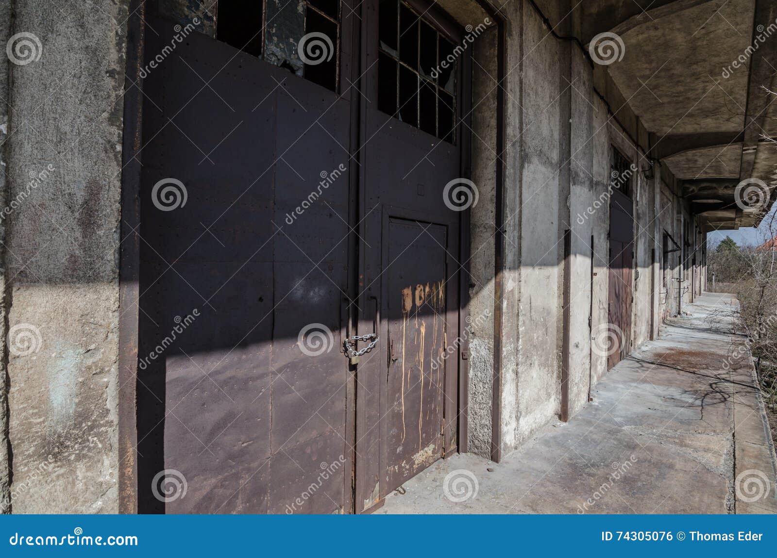 Iron gates in old factory stock photo. Image of glass - 74305076