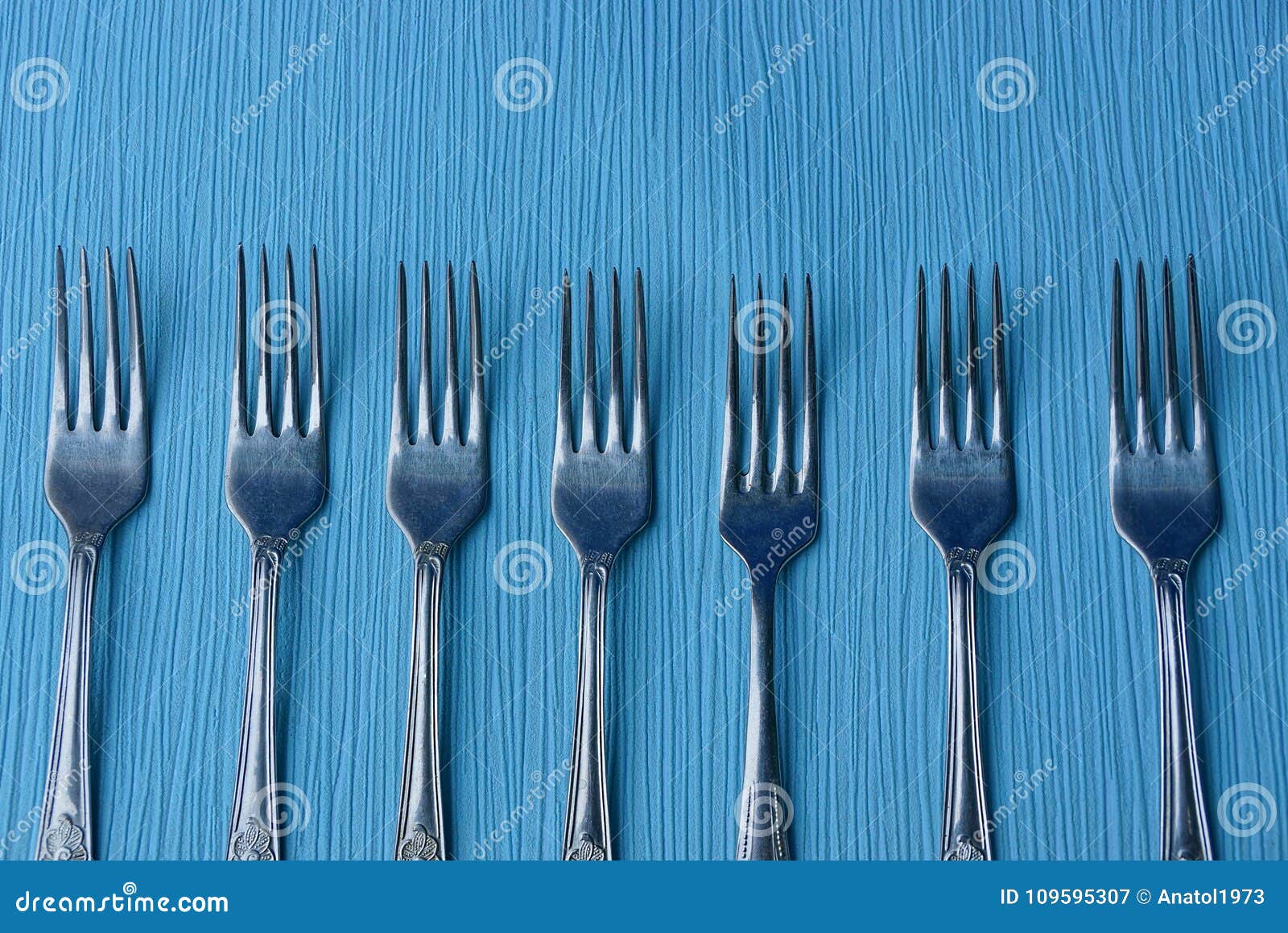 Iron Gray Forks on a Blue Table Stock Image - Image of accessory ...