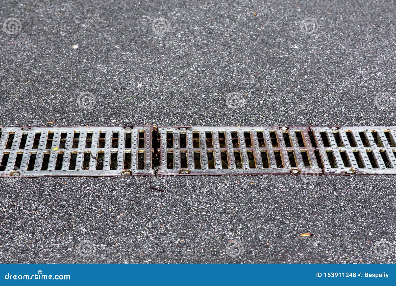 A Iron Grid Drainage System on an Asphalt Road. Stock Photo - Image of ...