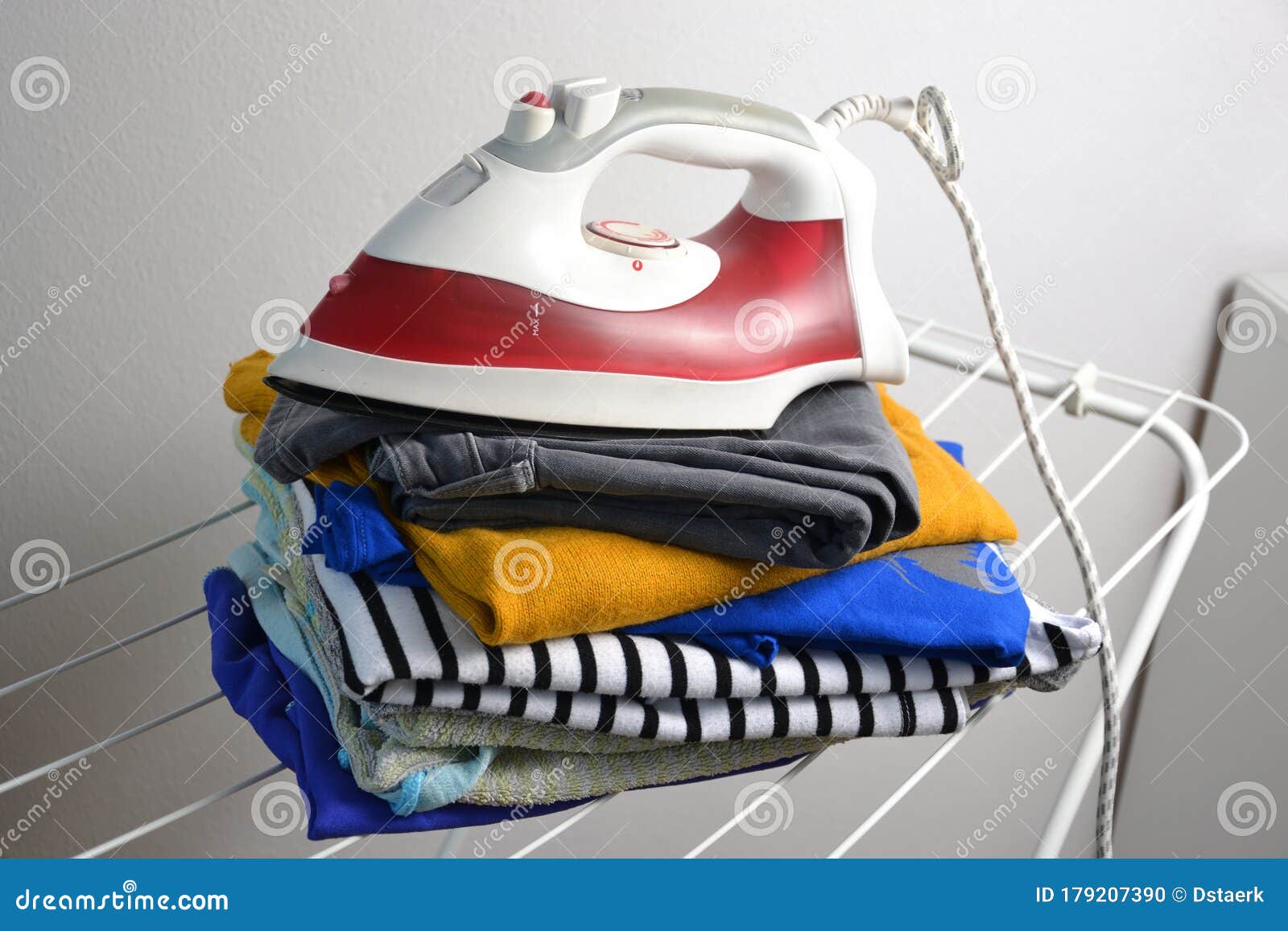 An Iron with Ironed Laundry Stock Photo - Image of plastic, clothing ...