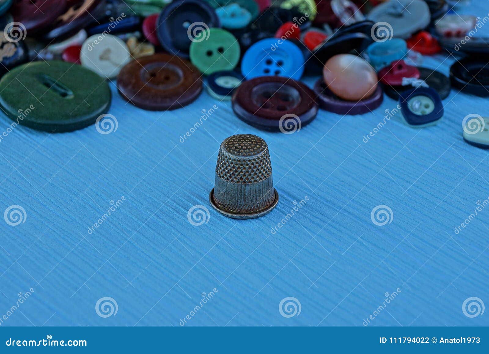 An Iron Thimble and a Pile of Colored Buttons on the Table Stock Photo ...