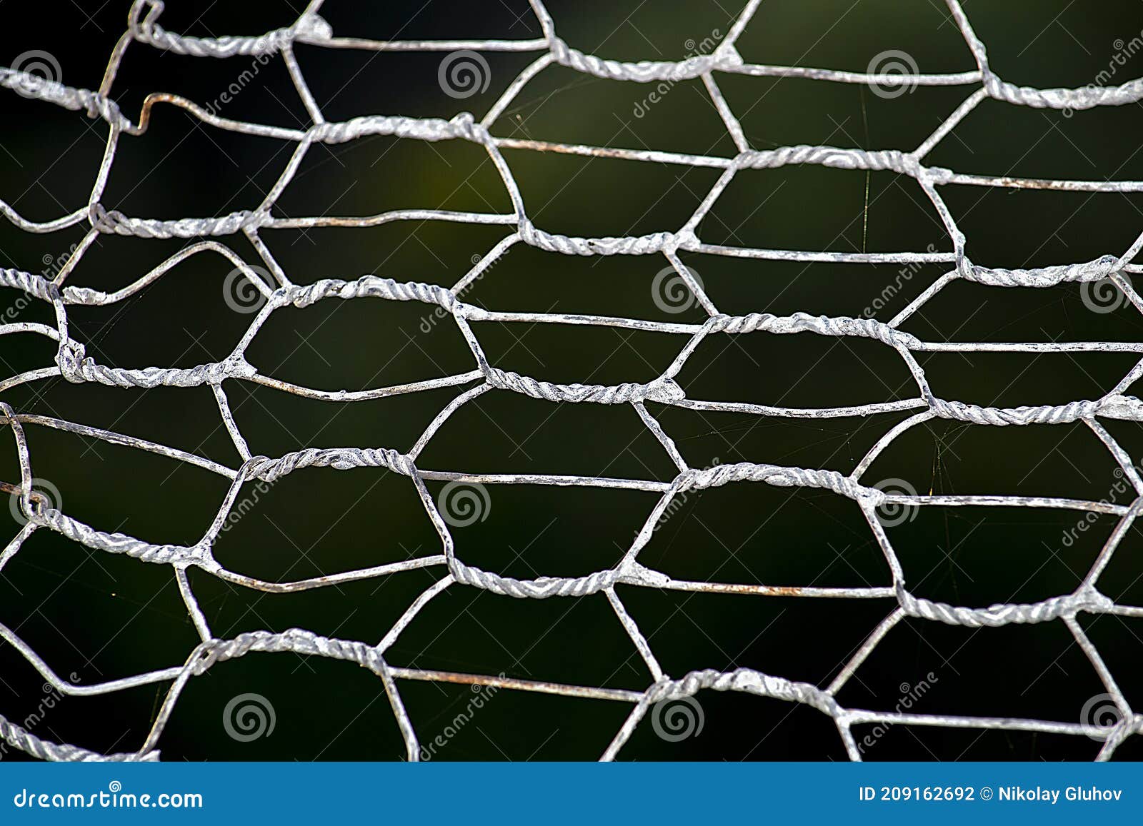Iron Wicker Mesh. Hexagonal Cell. Against A Dark Background Royalty ...