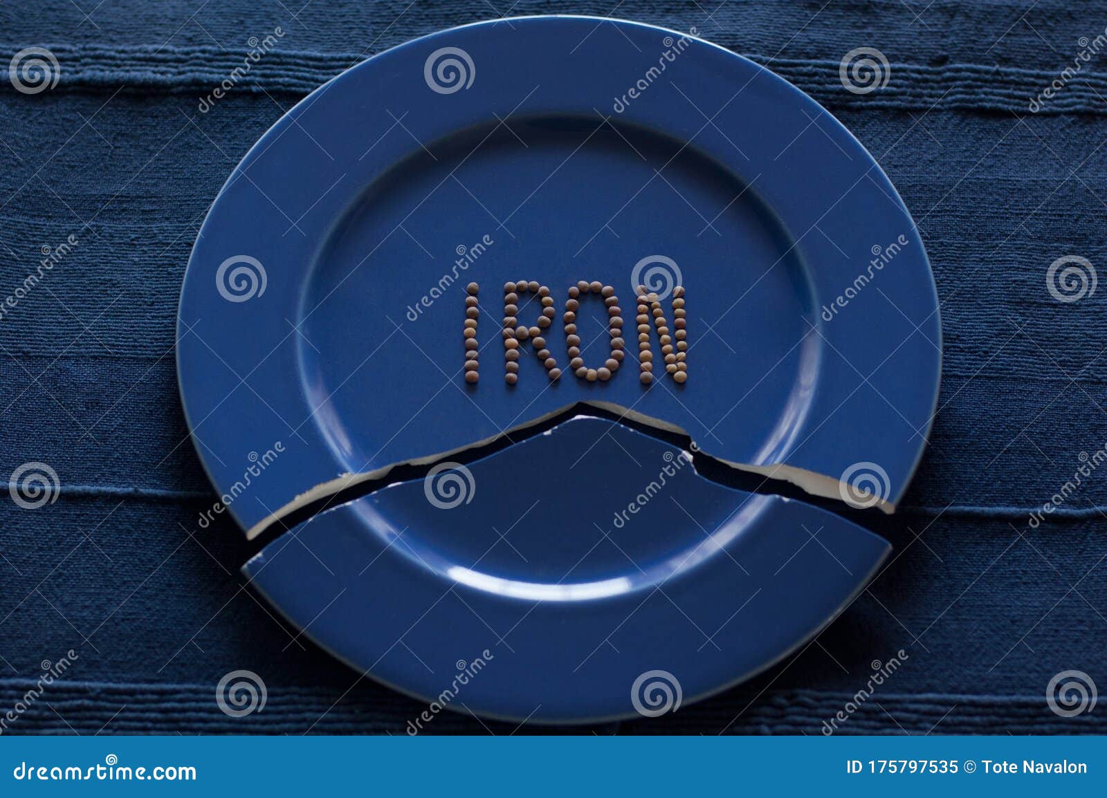 IRON Word Written by Lentil Seeds on Broken Blue Dish Stock Image ...