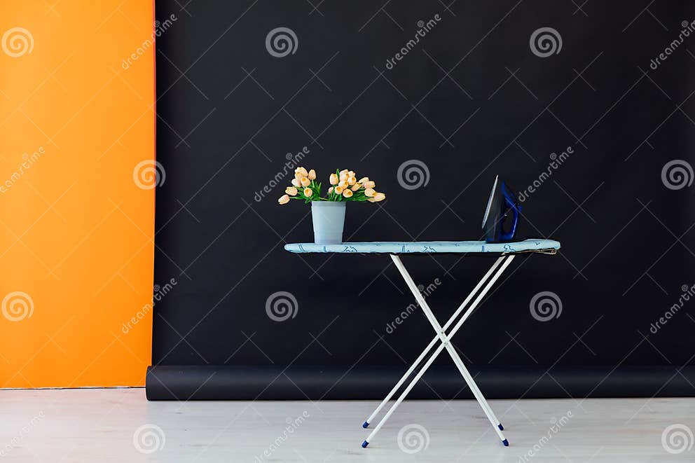 Ironing Board with Iron and Colors on a Black Background Stock Photo ...