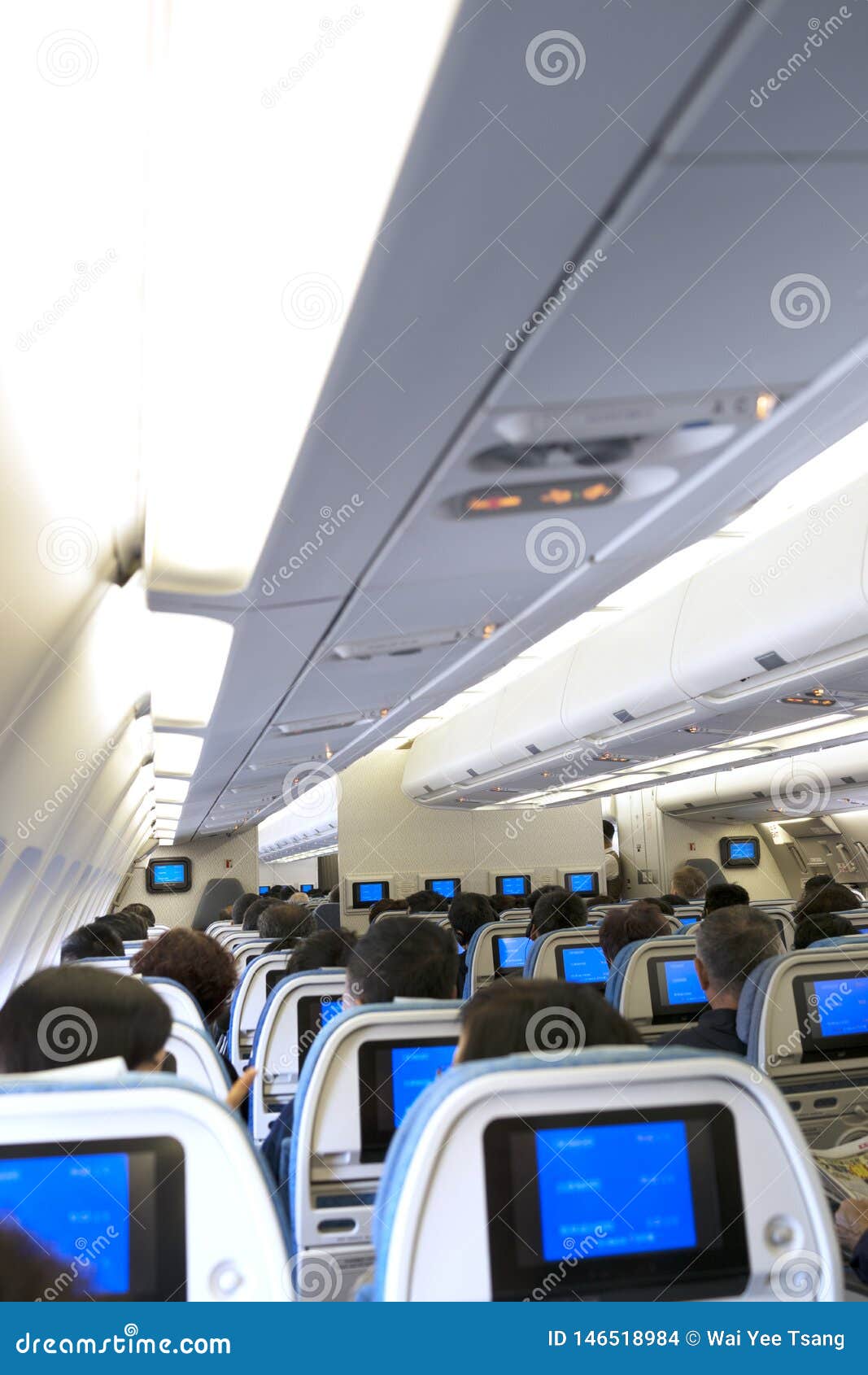 In Plane Cabin Full of Passengers during a Flight Viewed from the Back ...