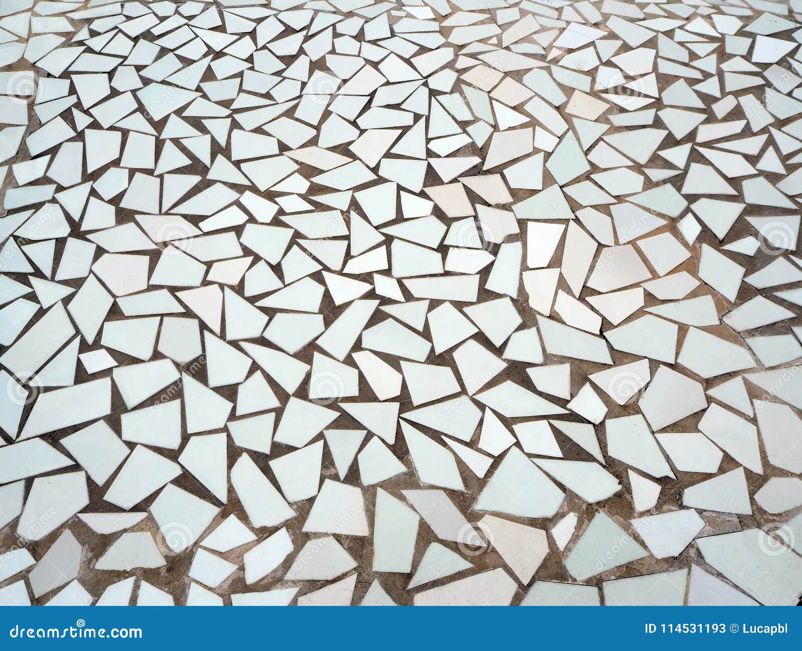 Irregular Shaped White Ceramic Tiles on a Concrete Wall. Abstract ...