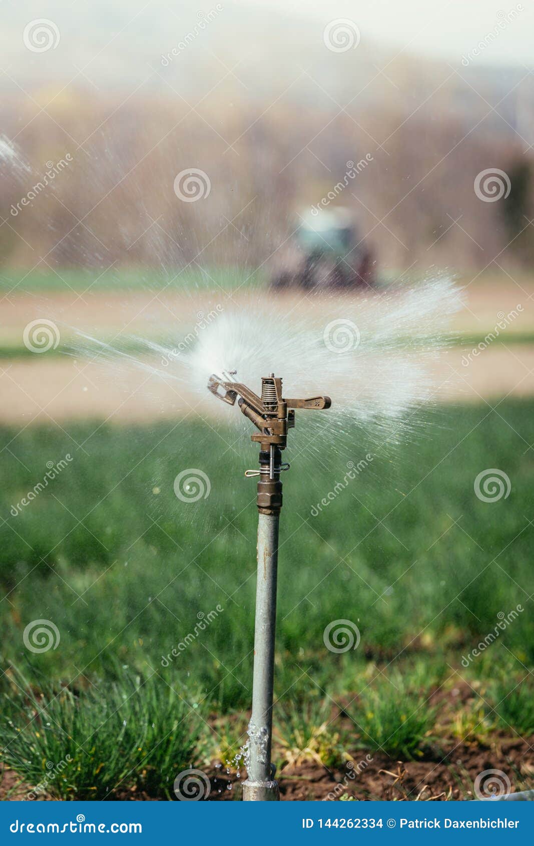 Irrigation Plant System on a Field, Agriculture. Tractor in the Blurry ...