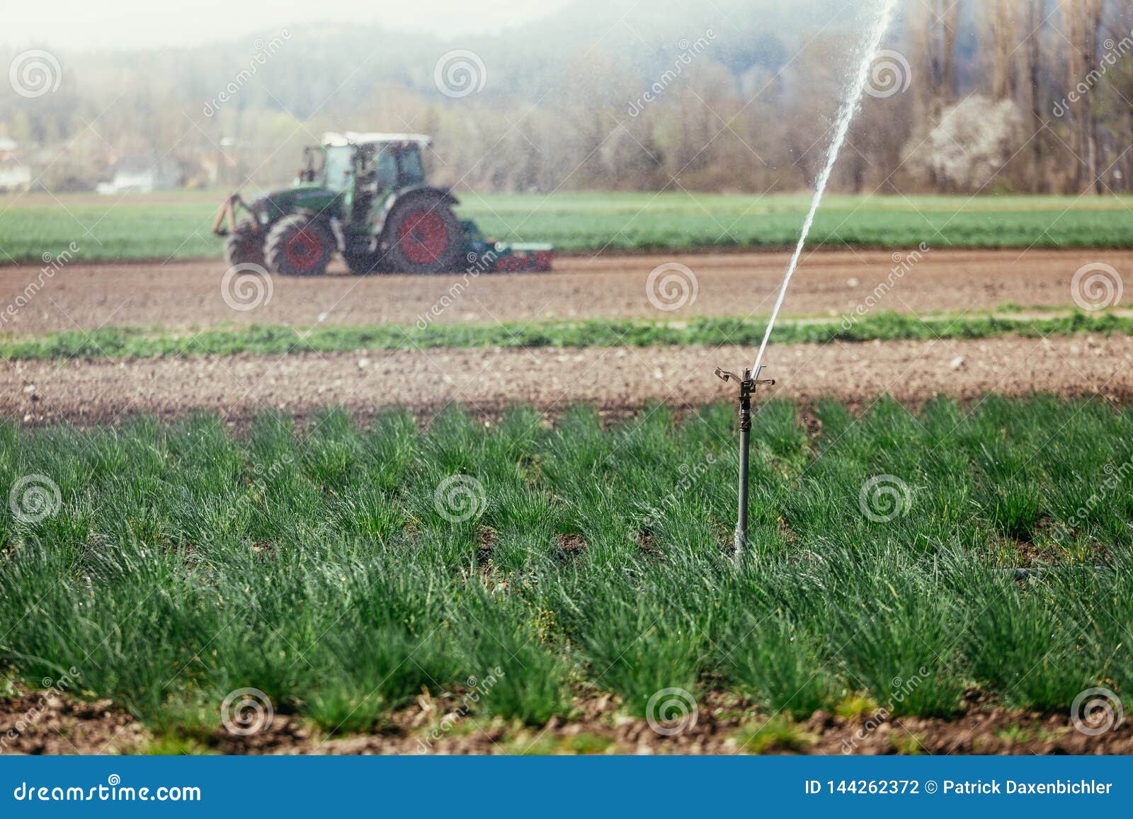 Irrigation Plant System on a Field, Agriculture. Tractor in the Blurry ...