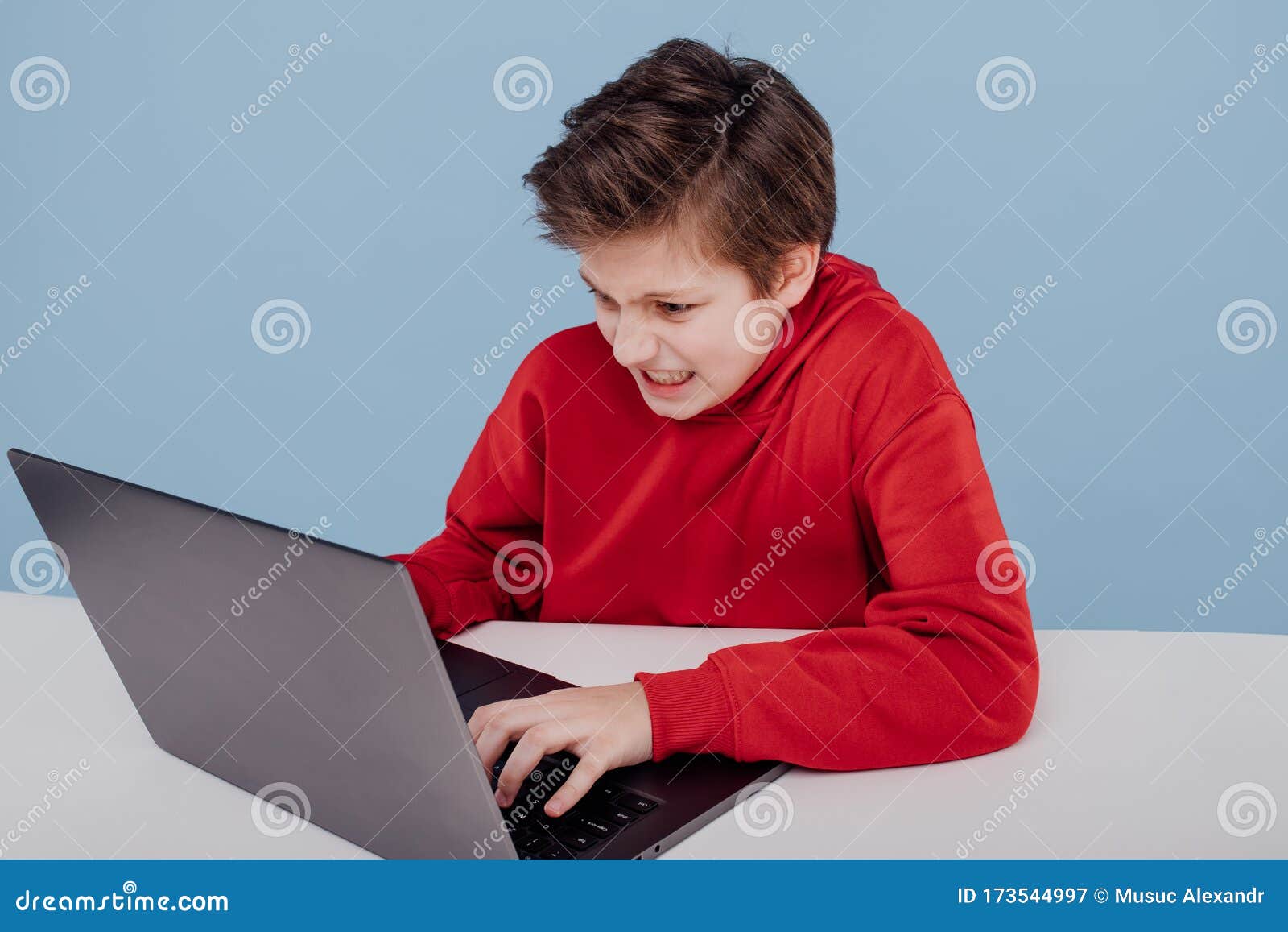 Irritated Child Boy in Red Sweatshirt Typing on Laptop Stock Image ...