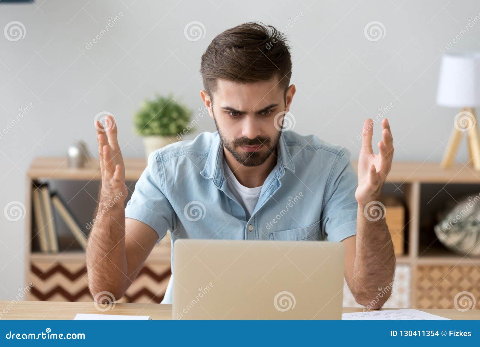 Irritated Man Looking at Laptop Screen Sitting at the Desk Stock Photo ...