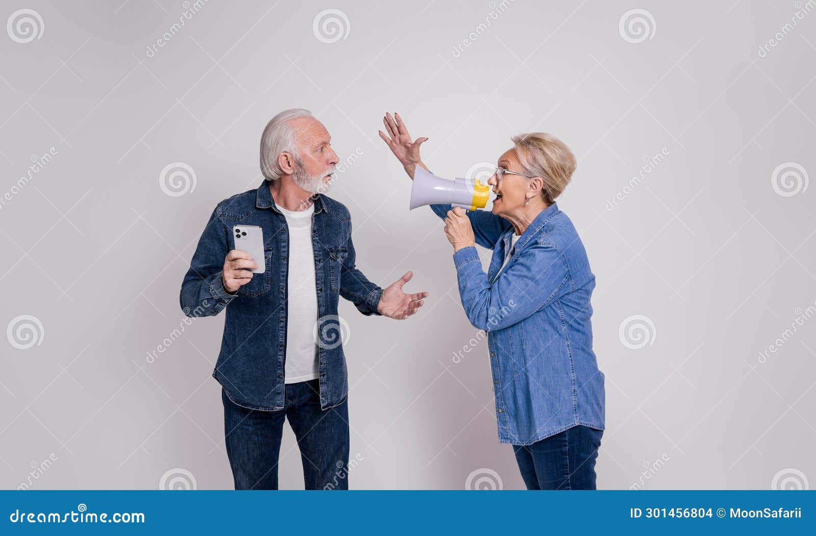 Irritated Mature Husband with Cellphone Looking at Wife Shouting Over ... Irritated Mature Husband with Cellphone Looking at Wife Shouting Over ...