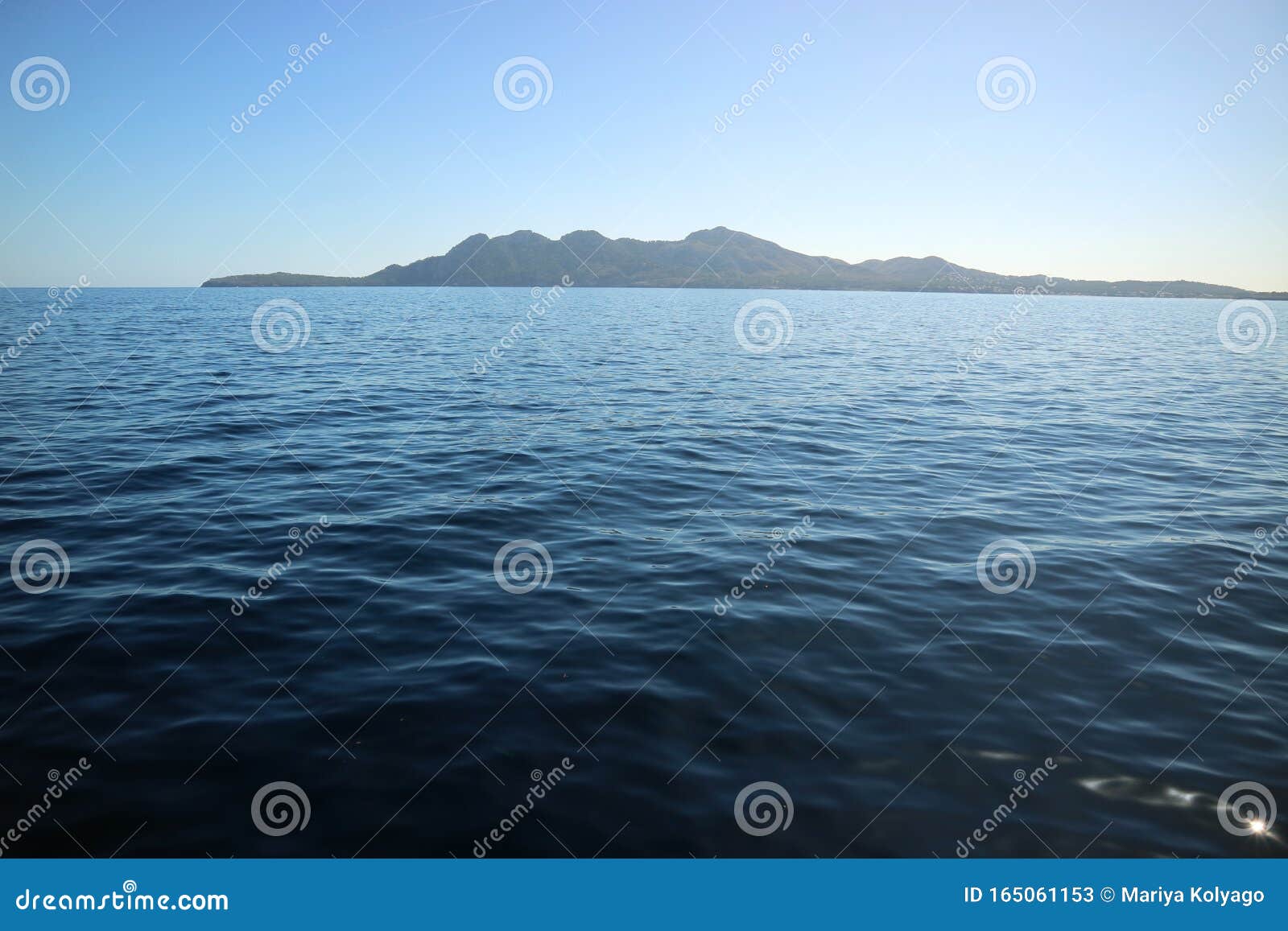 The Island in the Distance among the Waves of the Sea Open Water Stock ...