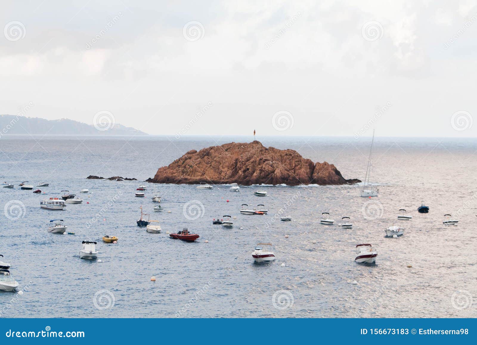 Island Formed of Rocks in the Middle of the Sea Surrounded by Boats ...