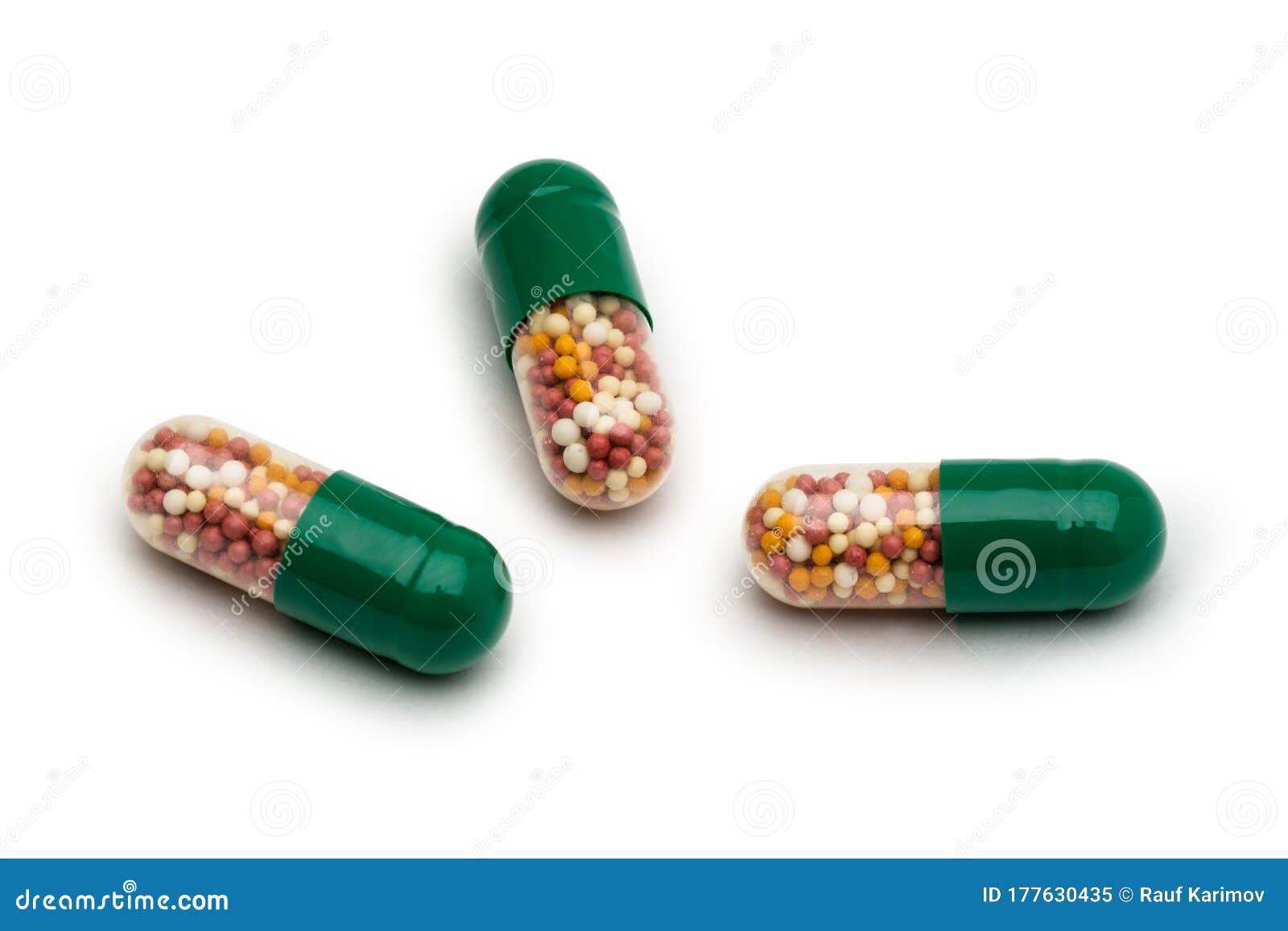 Isolate. Three Separate Green Capsules with Medicine on a White ...