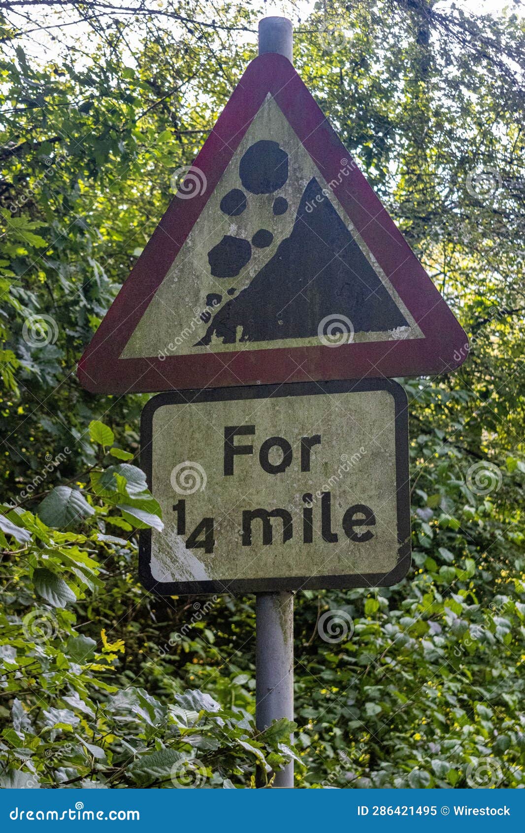Isolated Close-up of a Rock with a Warning Sign Warning of Falling Rock ...
