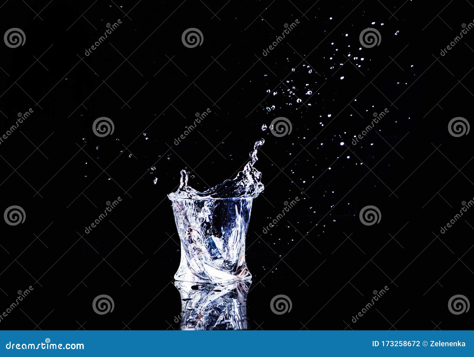Isolated Cold Water in a Glass with Splash and Cubes of Ice on Black ...