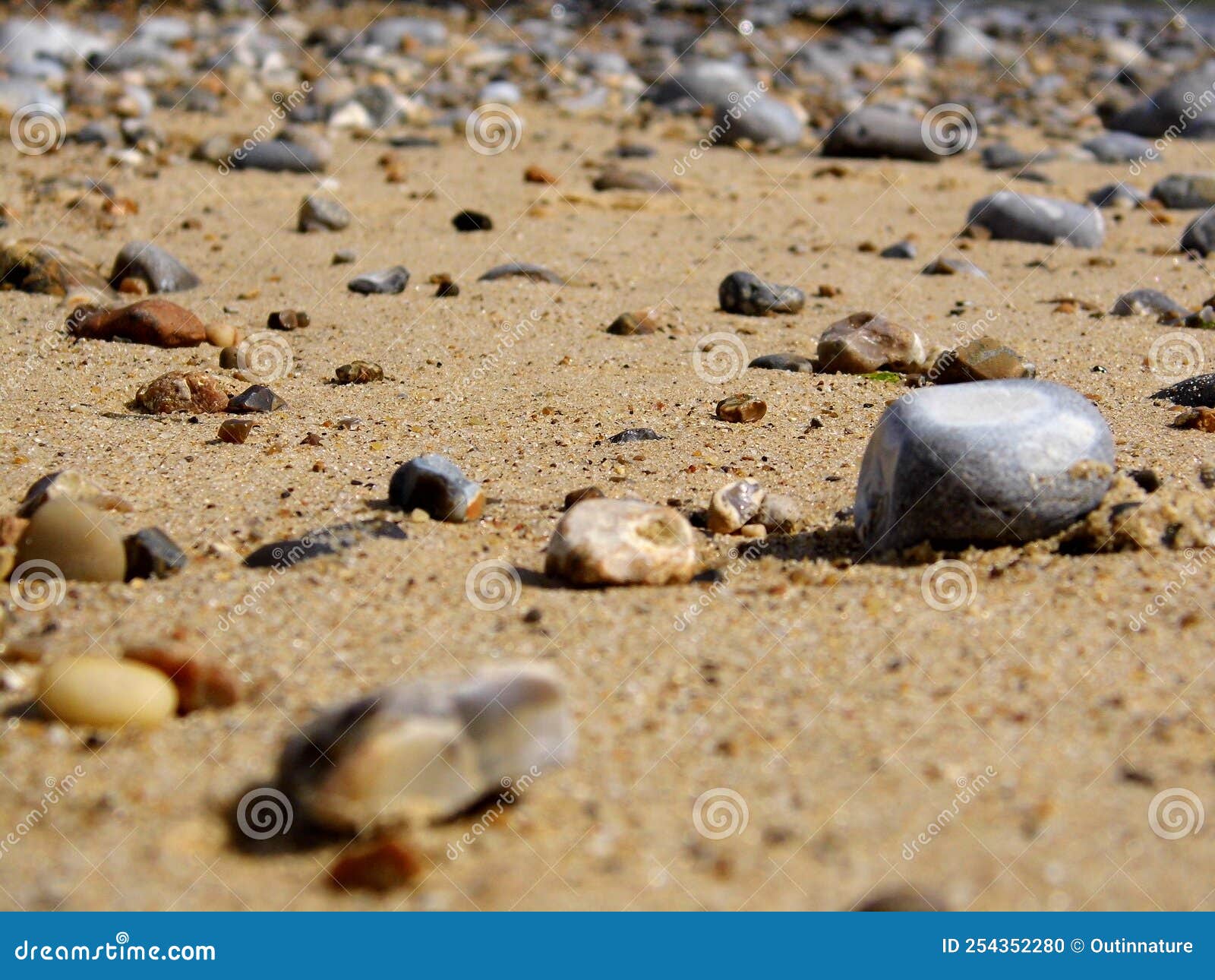 An Arty View of Beach Pebbles on a Sandy Beach Stock Photo - Image of ...
