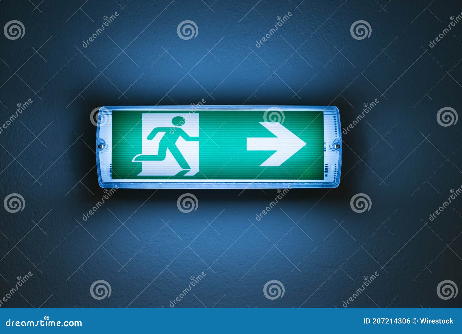 Isolated Shot of an Emergency Exit Sign on the Blue Wall Stock Photo ...