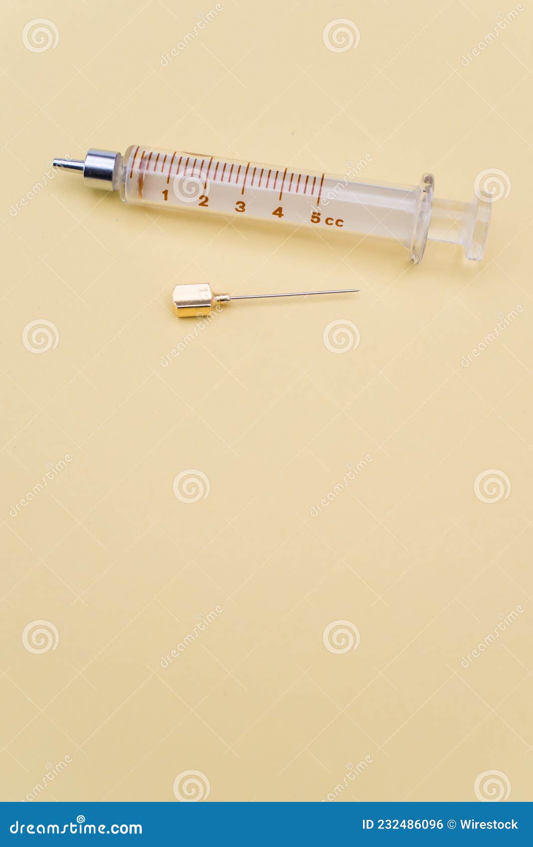 Isolated Sterilized Glass Injection Syringe on a Yellow Paper ...