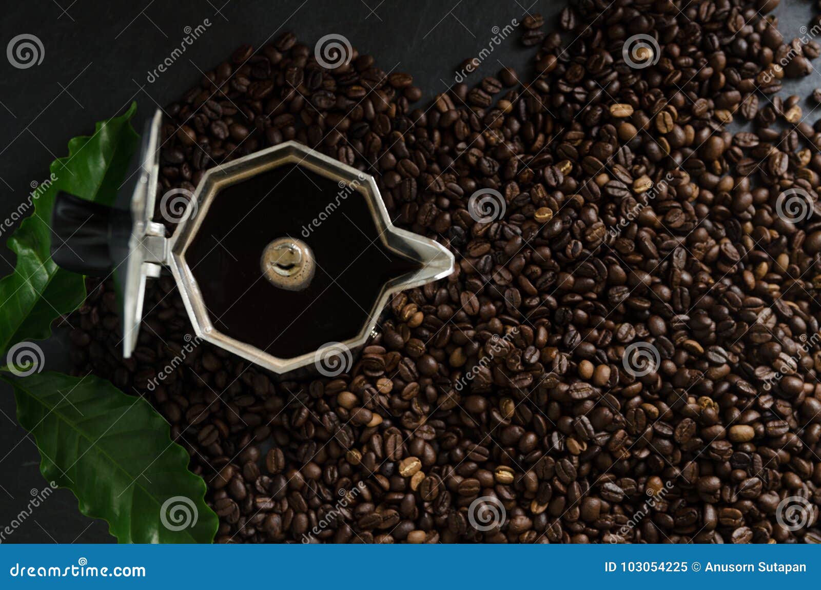 Italian Coffee Maker and Coffee Beans with Leaves on Brown Background ...