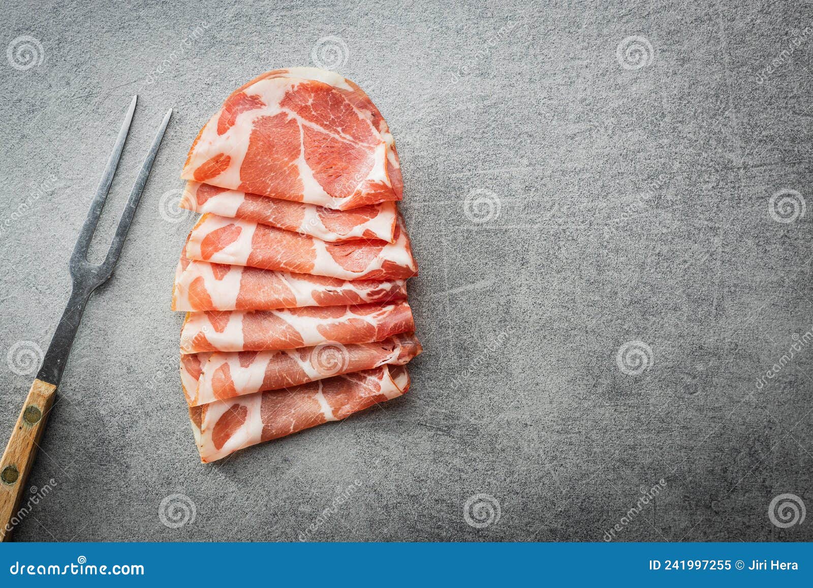 Italian Dried Ham. Coppa Stagionata with Fork on Kitchen Table Stock ...