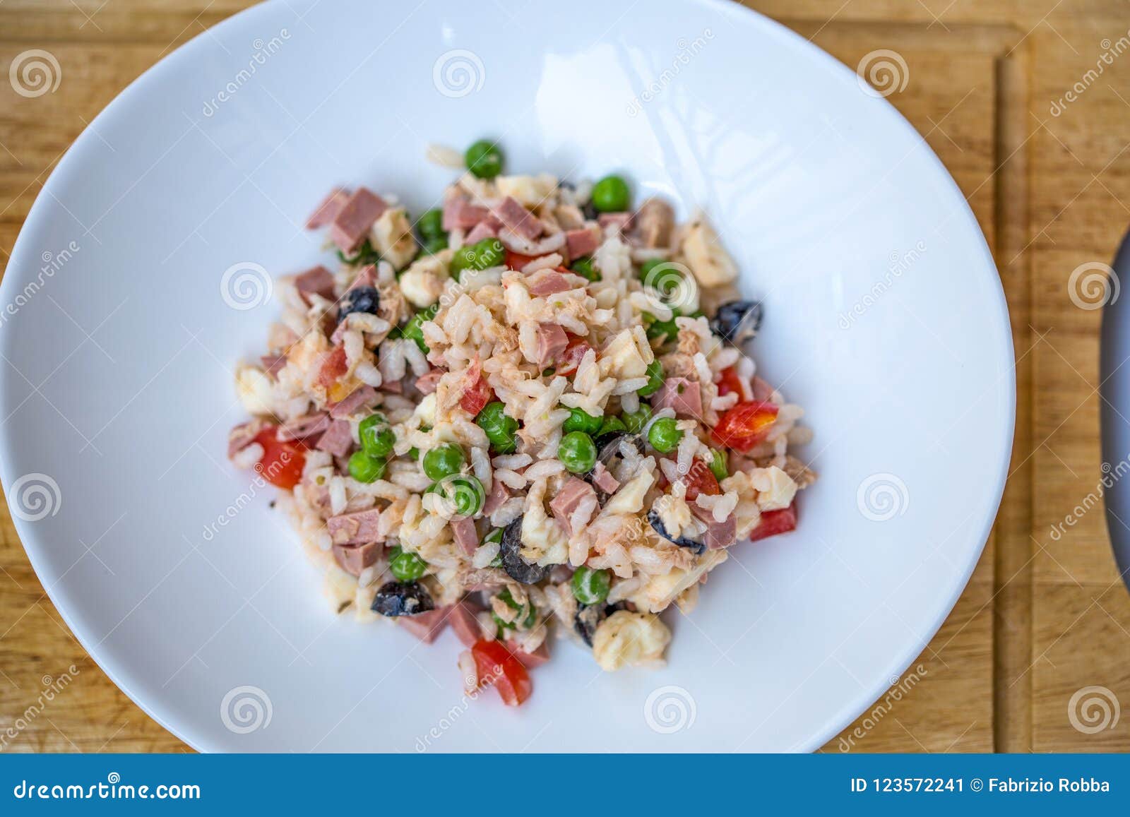 Italian Rice Salad or Cold Rice in a White Plate on a Chopping Board ...